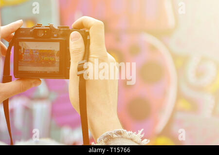 Young caucasian male graffiti artist drawing big street art painting in ...