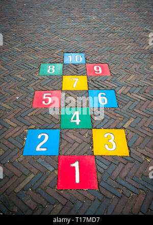 Hopscotch game painted by children on the playground with a green ...
