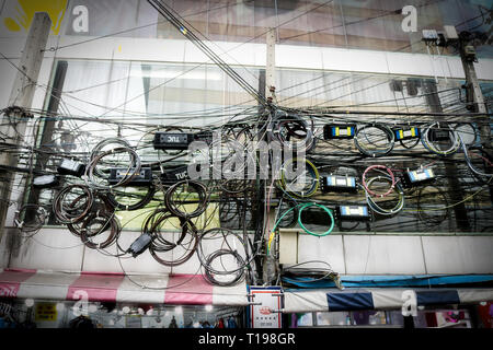 Crazy messy chaos wires cables on Electric poles Stock Photo - Alamy