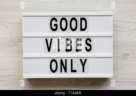 'Good vibes only' words on modern board over white wooden surface, top ...