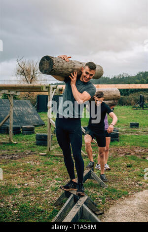 Man carrying tree trunk Stock Photo - Alamy