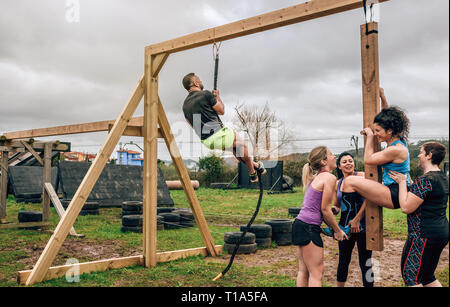 Participant in a obstacle course doing irish table Stock Photo - Alamy