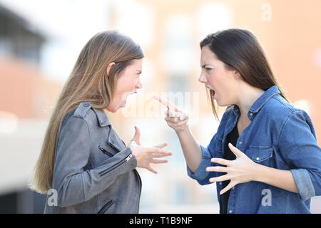 Two aggressive women arguing and shouting isolated on a white ...