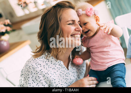 Mother and child with colorful eggs. Mom and baby with bunny ears ...