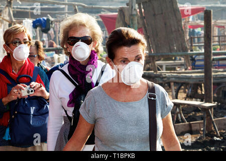 A foreign tourist wears a mask as a precaution at Kashgar Market ...