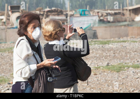 A foreign tourist wears a mask as a precaution at Kashgar Market ...