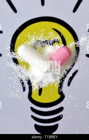 powder of an open capsule on a smartphone screen with logo of facebook ...