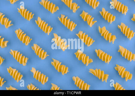 Giant fusilli pasta on blue background. Close up view Stock Photo - Alamy