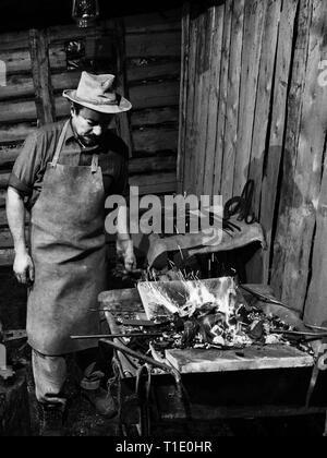 Verona, Italy - December 26, 2018: Blacksmith heats the iron on the ...