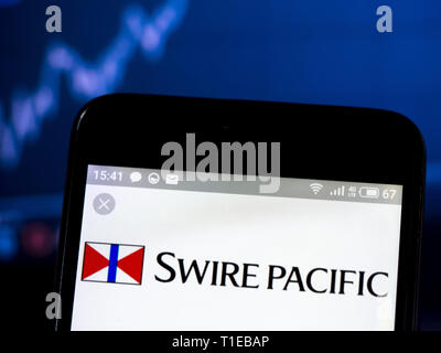 In this photo illustration a Swire Group logo seen displayed on a smart ...