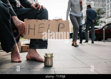 Man without shoes standing on a flooded sidewalk in Pacific Beach next ...