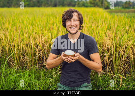 Portrait of man holding a bowl of rice Stock Photo - Alamy
