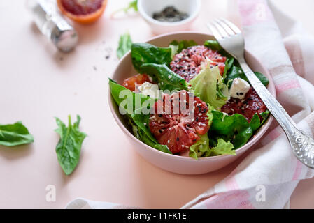 Spring fresh salad with blood orange, lettuce, spinach and sesame seeds ...