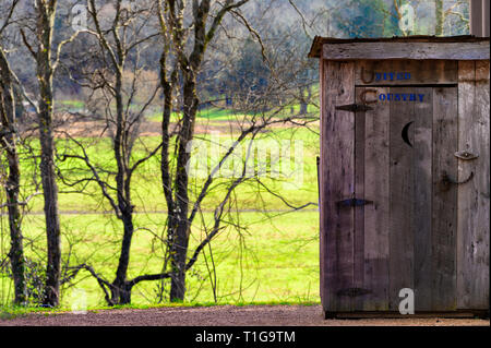 An old wood outhouse sits on the grounds of the historic Pratt Museum ...