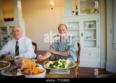 Portrait two men at table Stock Photo - Alamy