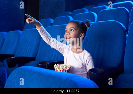 Side view of shocked child in pajama looking at Christmas stocking near ...