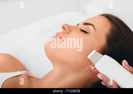 Beautiful woman receiving ultrasonic facial exfoliation procedure of ...