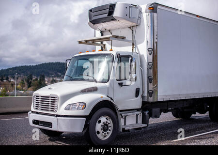 The middle-duty white day cab compact semi truck for local shipping and ...