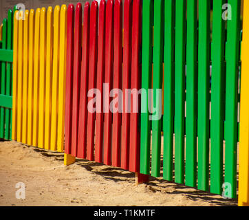 Multi colored rainbow wooden fence in autumn, garden background, soft ...