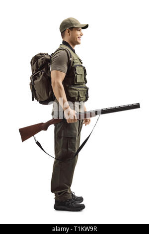 Profile shot of a hunter standing with a rifle isolated on white ...