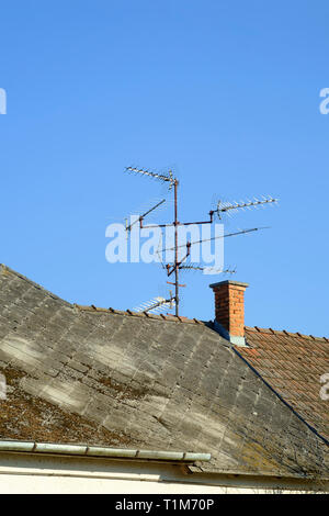 multiple narrow band uhf television aerials on a house roof in hungary ...