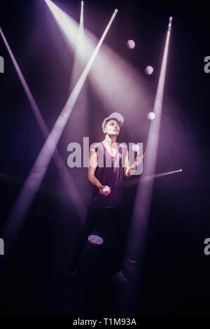 Male performer juggling on stage Stock Photo - Alamy