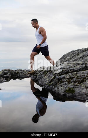 Chinese mid adult man getting ready to go out and workout Stock Photo ...
