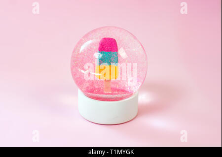 Beautiful snow ball with ice cream and glitter inside palm tree leaf ...