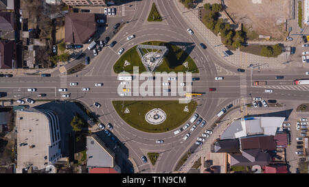 top down view of road intersection in the forest at summer, drone shot ...