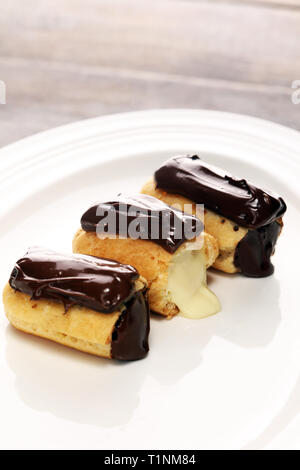 Traditional French dessert. Eclair with chocolate icing. Pastery ...