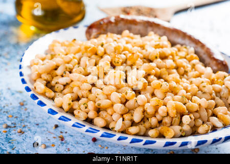 a plate with botifarra amb mongetes, fried white beans and sausage ...
