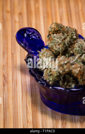 blue glass bowl with a person artistically built into the base loaded ...