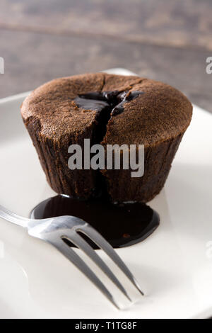 Coulant chocolate cake on wooden table Stock Photo - Alamy