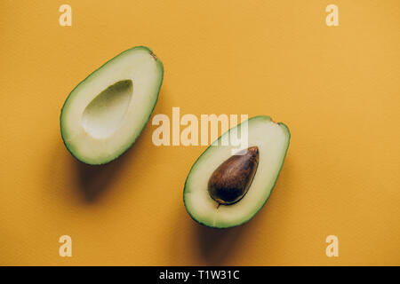 Summer food pattern. Avocado halves on blue background. Top view. Flat ...