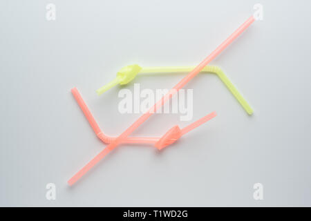 Disposable plastic knotted drinking straw. Conceptual photo about ...