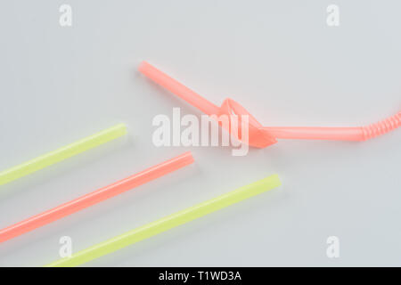Disposable plastic knotted drinking straw. Conceptual photo about ...
