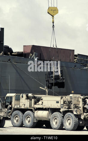 A M984 Heavy Expanded Mobility Tactical Truck wrecker towed a M917 20 ...