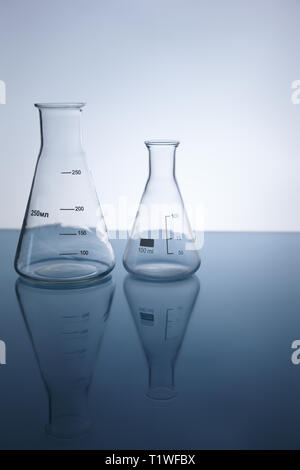 two glass science flask in dark green biotechnology laboratory with ...