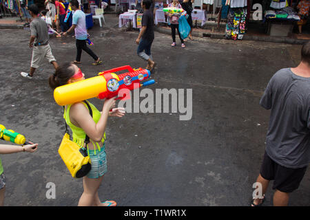 People with water guns celebrating the Thai new year of Songkran in ...