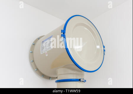 Collective CBRN filtration system attached to a valve in the wall of a ...