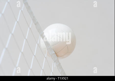 Close up of Volleyball spiking and hand blocking over the net under ...