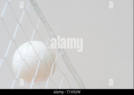 Close up of Volleyball spiking and hand blocking over the net under ...