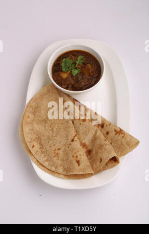 Chapatti roti or chapati, curry chicken, biryani rice, salad, masala ...