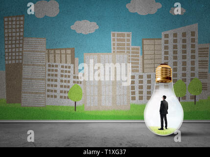 Businessman trapped in bulb Stock Photo - Alamy