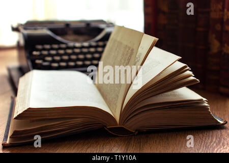 Vintage typewriter with book on table in garden Stock Photo - Alamy
