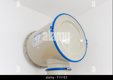 Collective CBRN filtration system attached to a valve in the wall of a ...