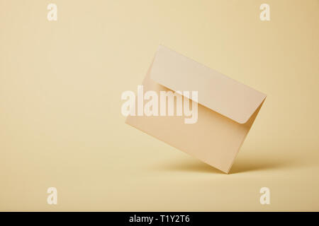 beige and pastel envelope on yellow background with copy space Stock ...