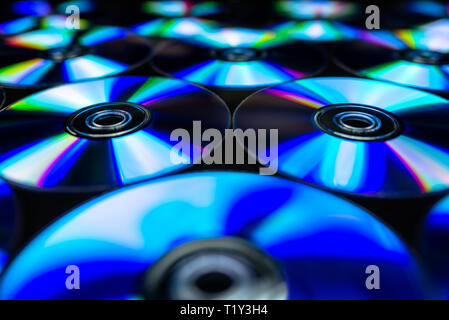 CDs / DVDs lying on a black background with reflections of light Stock ...