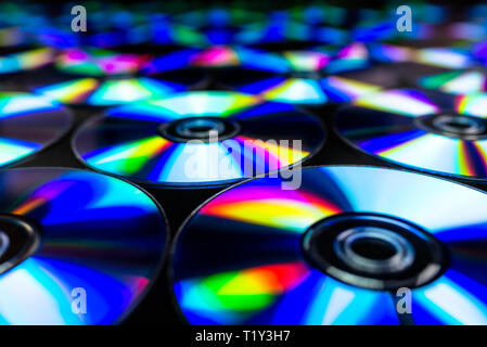 CDs / DVDs lying on a black background with reflections of light Stock ...