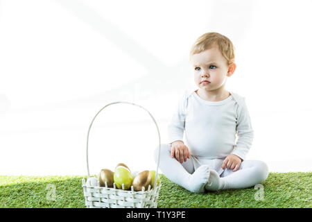 Colorful eggs on grass or straw for Easter Stock Photo - Alamy